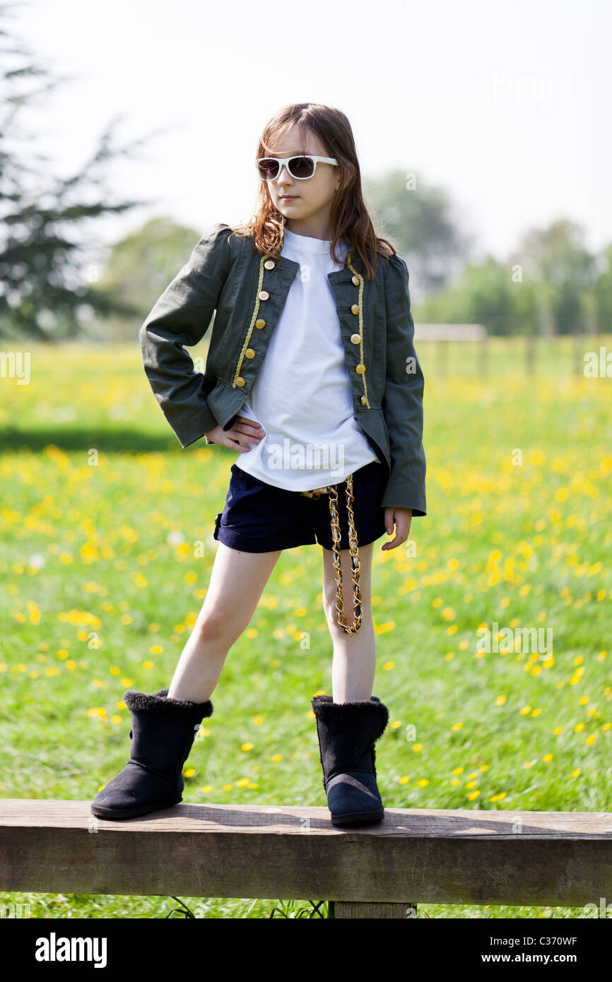 Young girl posing on a bench Stock Photo - Alamy