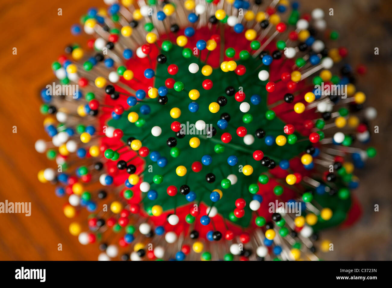 Close up of multi colored pins in red pin chushion Stock Photo - Alamy