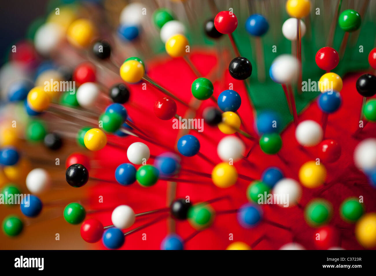 Close up of multi colored pins in red pin chushion Stock Photo - Alamy