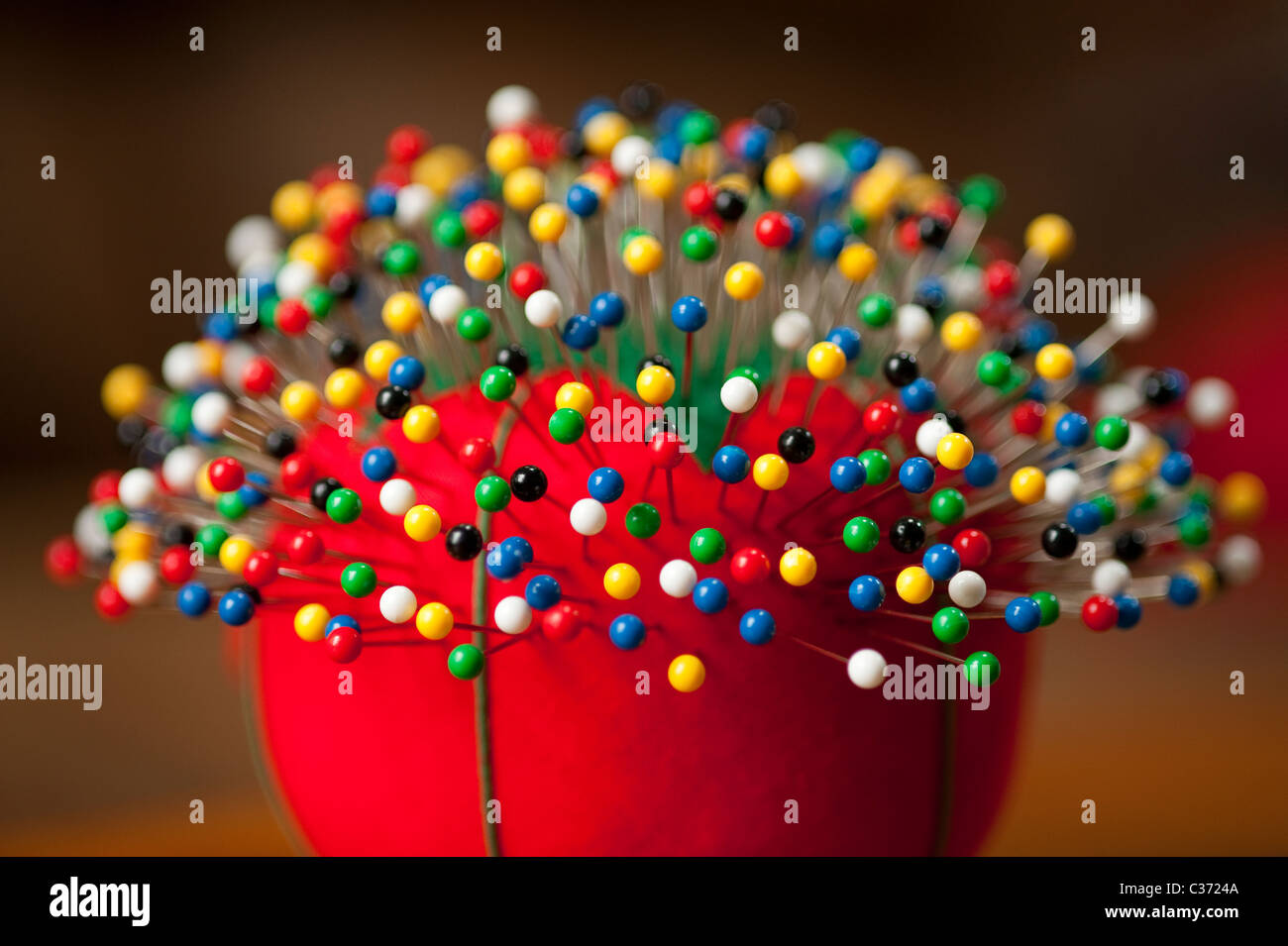 Close up of multi colored pins in red pin chushion Stock Photo - Alamy