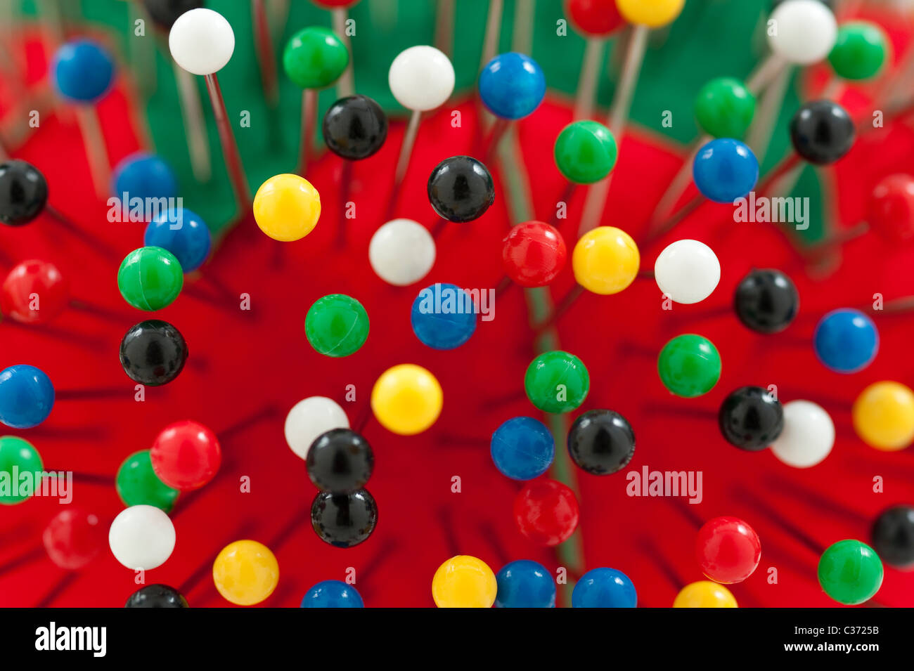 Red pin cushion with multi colored pins stuck in cushion Stock Photo ...