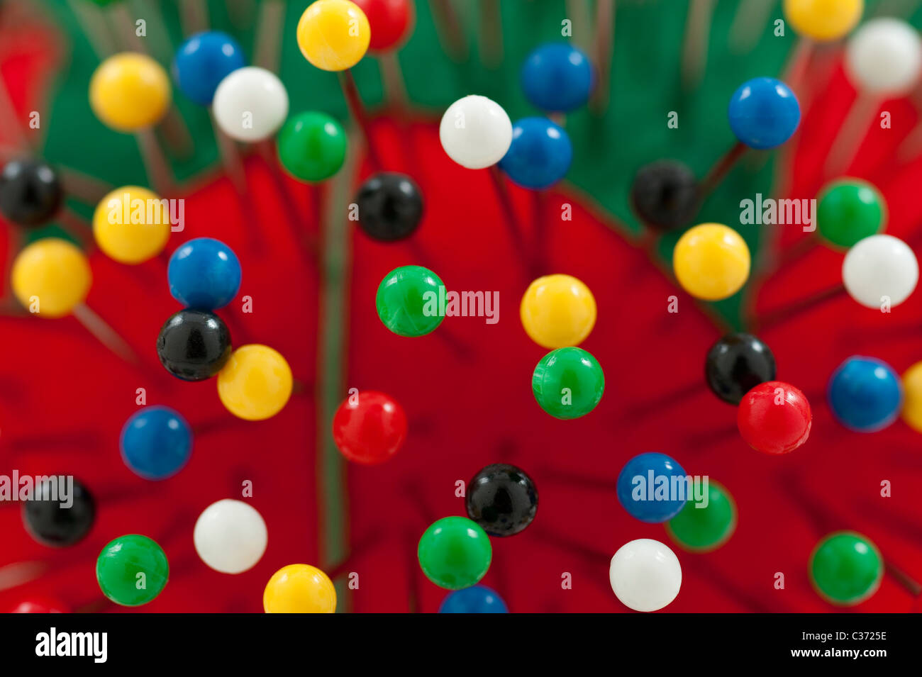 Red pin cushion with multi colored pins stuck in cushion Stock Photo ...