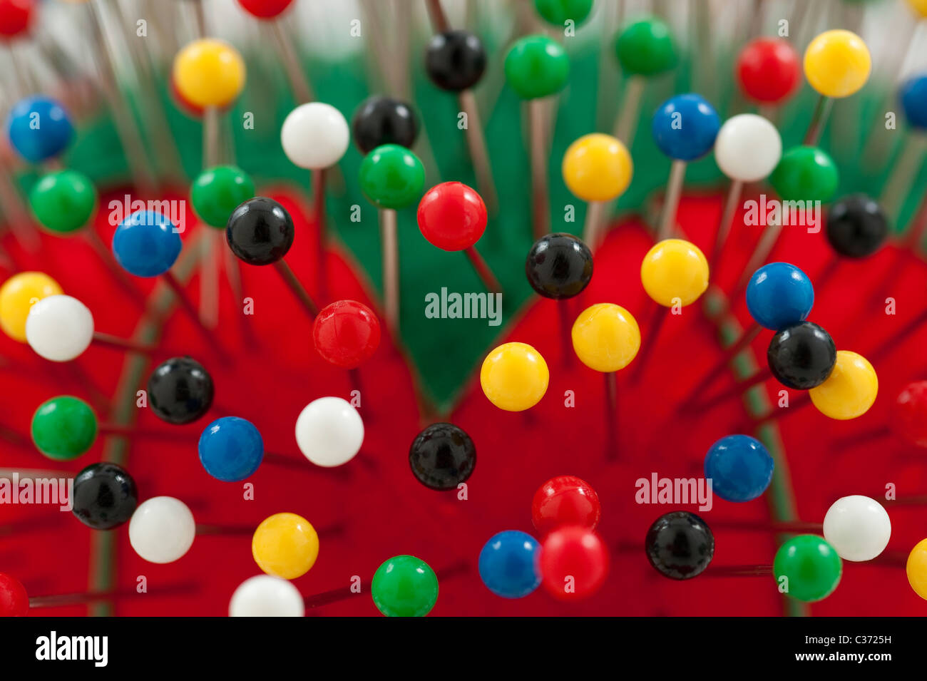 Red pin cushion with multi colored pins stuck in cushion Stock Photo ...
