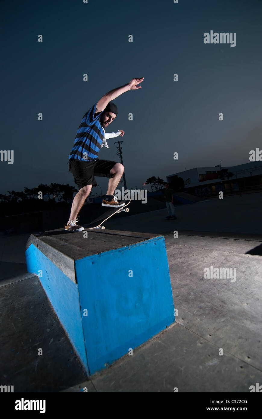 Skateboarder on a slide at night at the local skatepark Stock Photo - Alamy