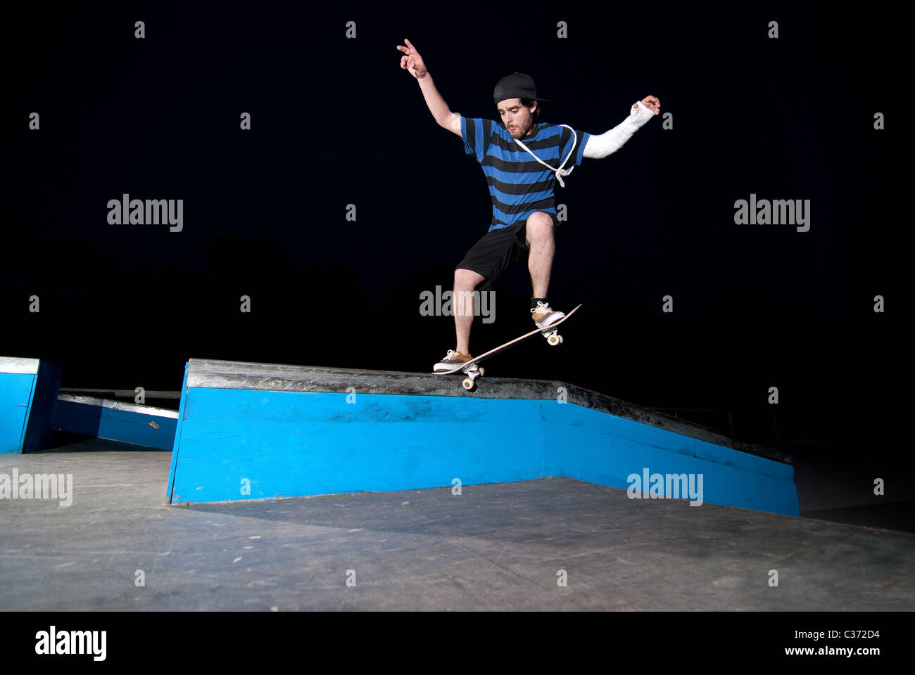 Skateboarder on a slide at night at the local skatepark Stock Photo - Alamy