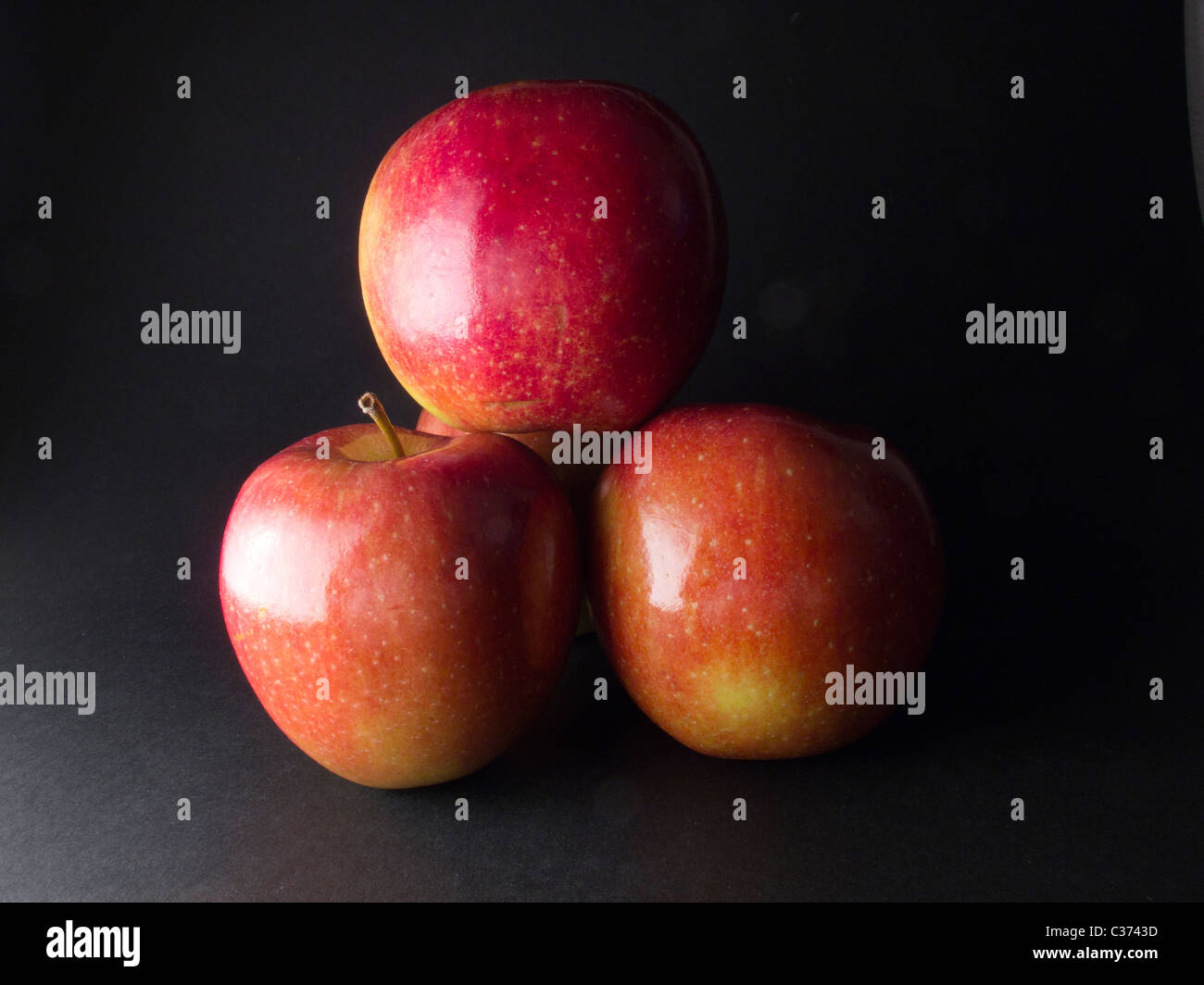 four red apples and fresh on a black background Stock Photo - Alamy