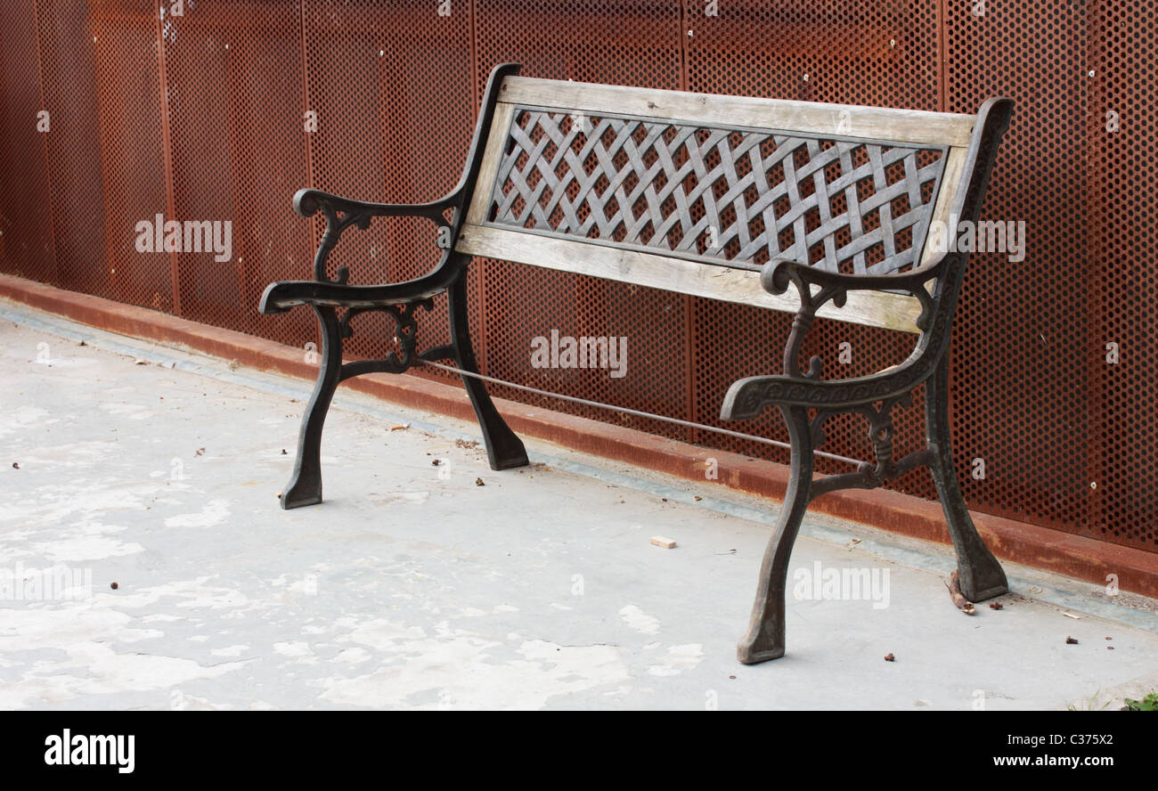 old rusty bench near old metal wall Stock Photo - Alamy