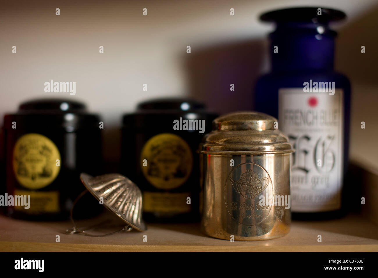 Tea jars and strainer on shelf Stock Photo - Alamy