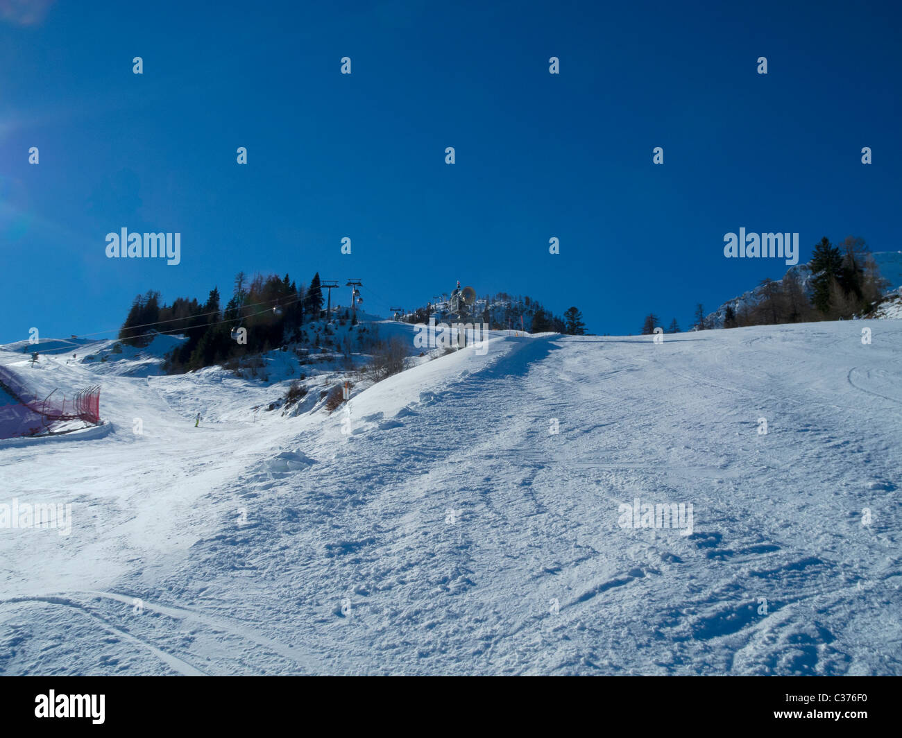 A fresh primed ski slope with a cloudless blue sky Stock Photo - Alamy