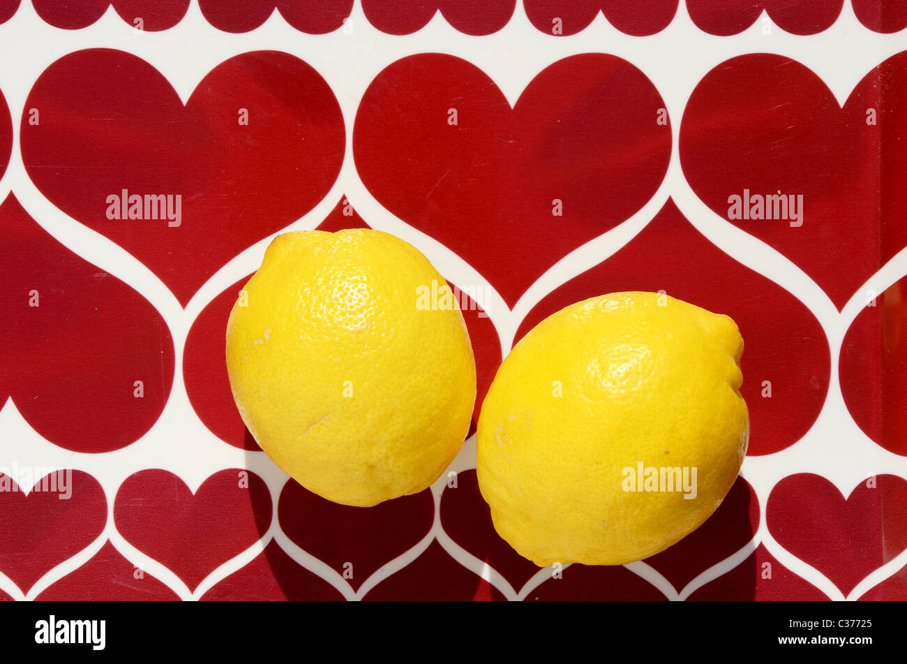 two yellow lemons on hearts background Stock Photo - Alamy
