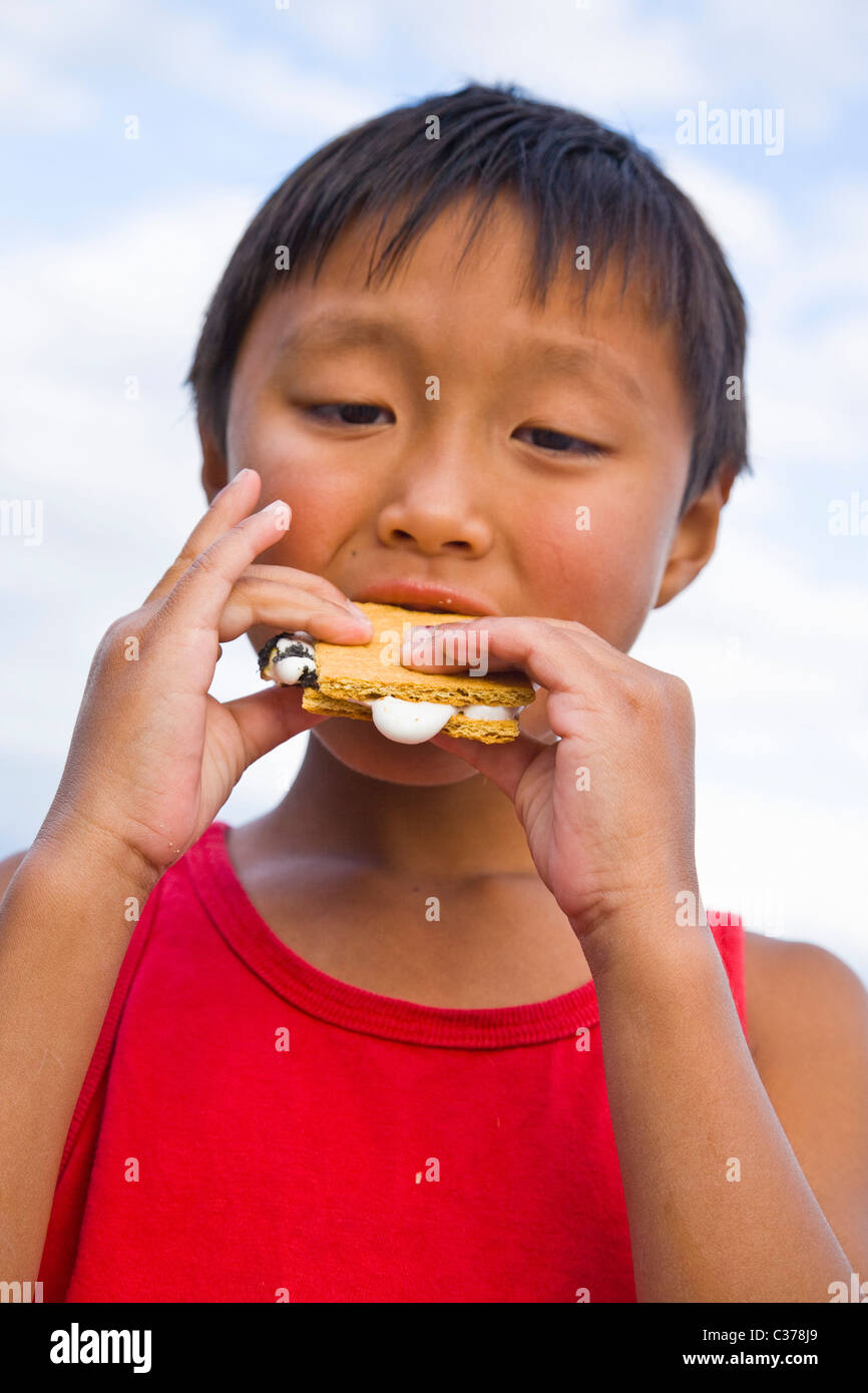 boy eating s'more outdoors Stock Photo - Alamy
