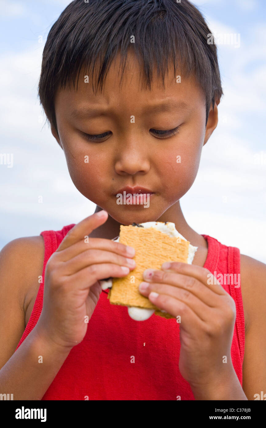 boy eating s'more outdoors Stock Photo - Alamy
