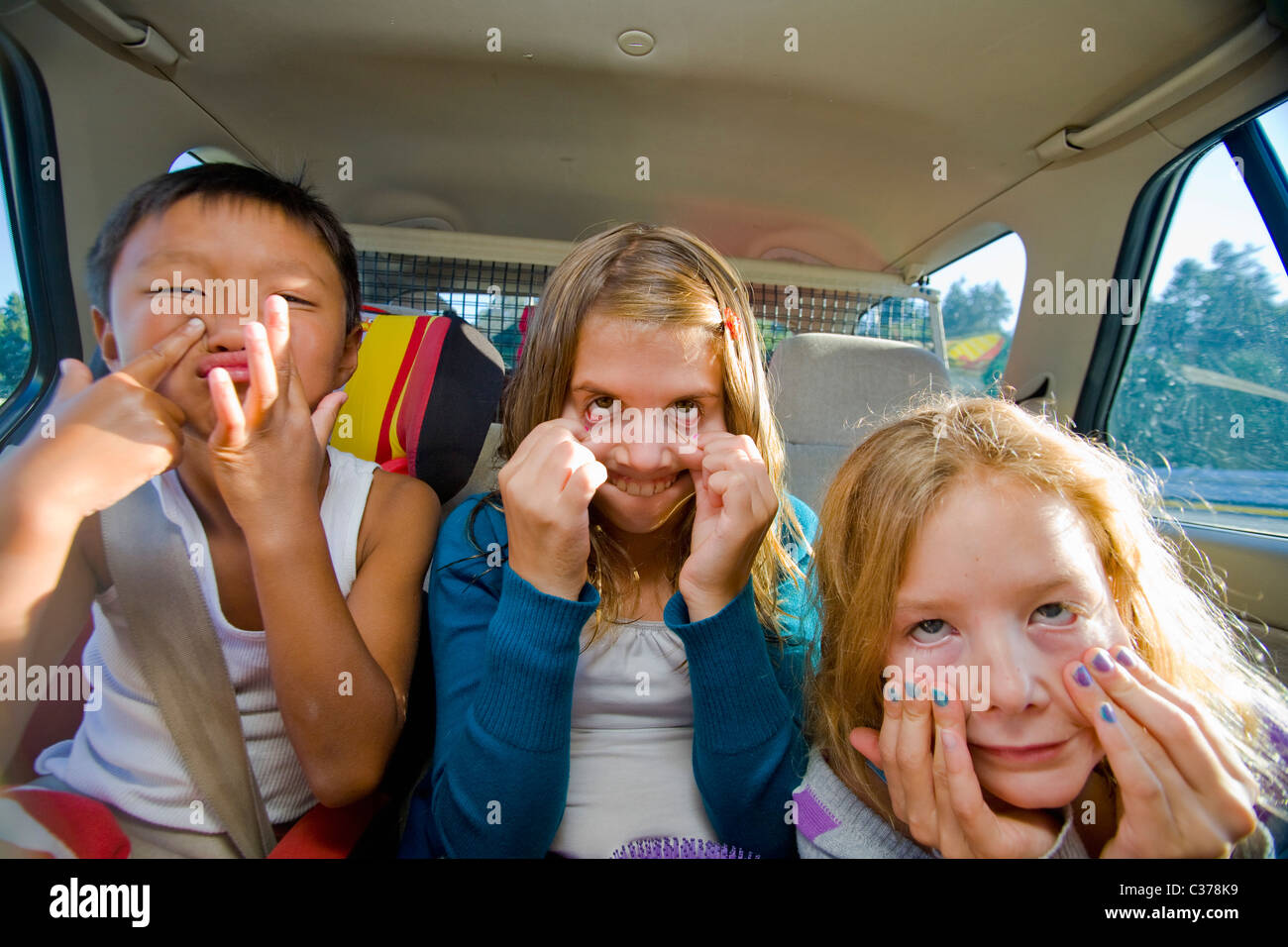 Portrait group children making faces hi-res stock photography and ...