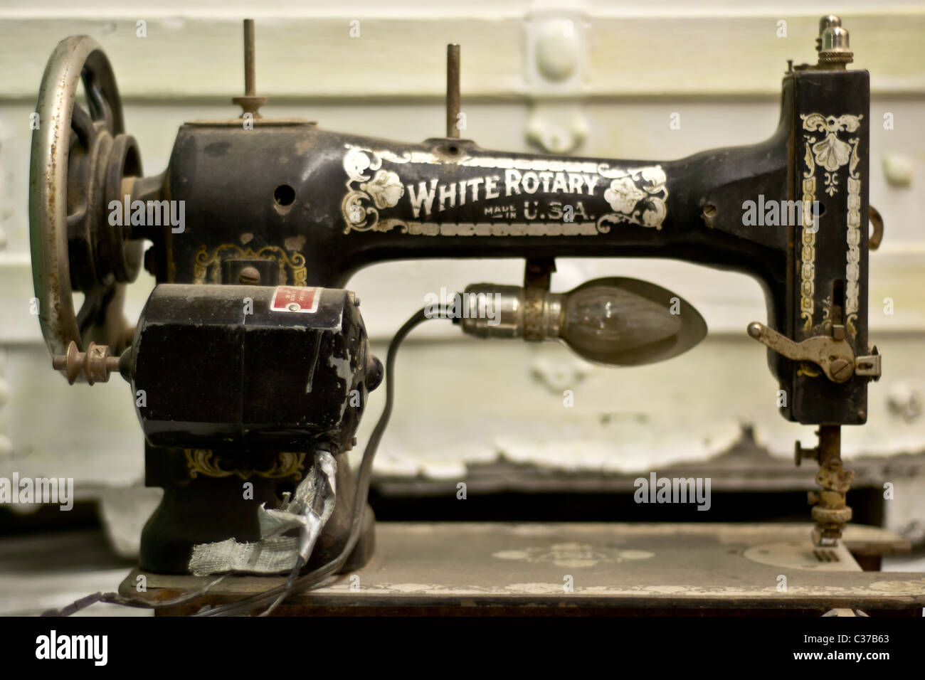 Very old sewing machine against a blurred background Stock Photo - Alamy