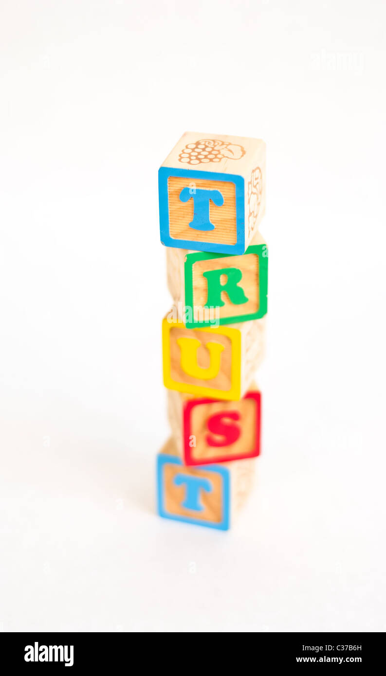 Vintage alphabet blocks spelling out TRUST Stock Photo - Alamy