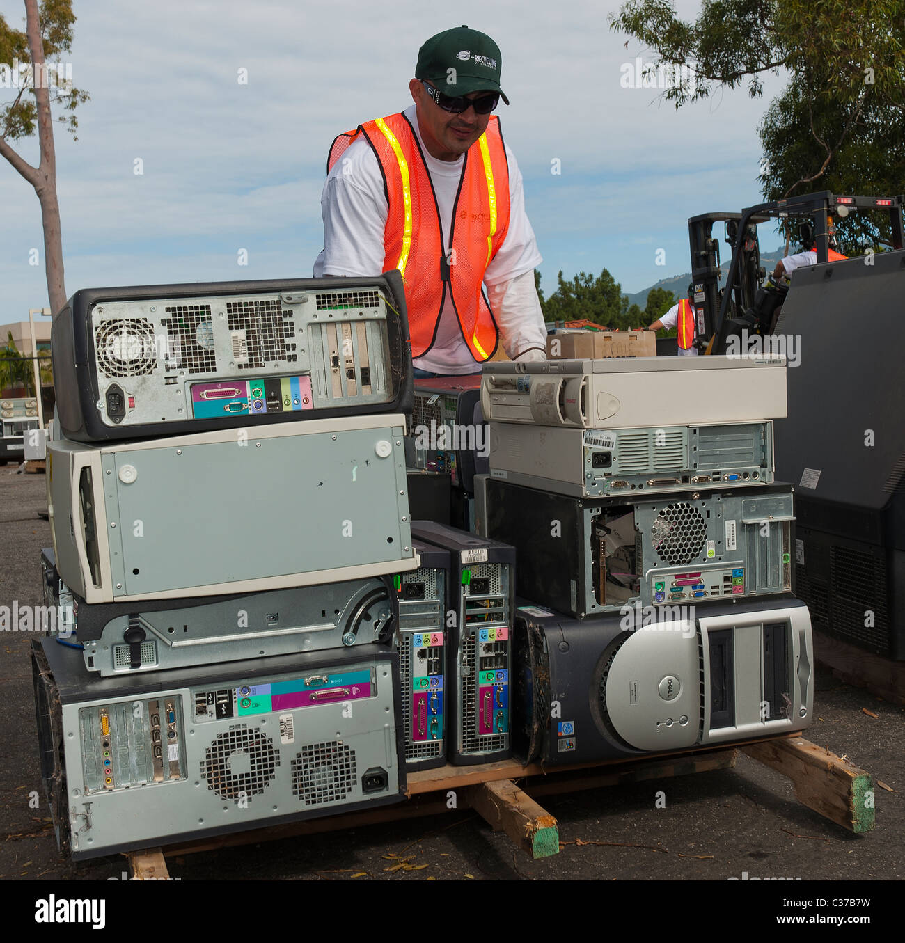 Recycling workers help in the collection, sorting, and packing of ...