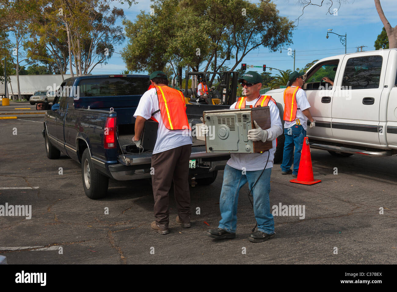 Recycling workers help in the collection, sorting, and packing of ...
