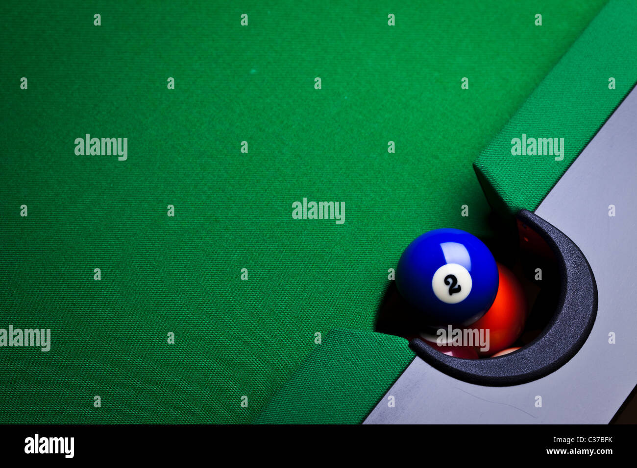 Billiard balls over green table Stock Photo - Alamy