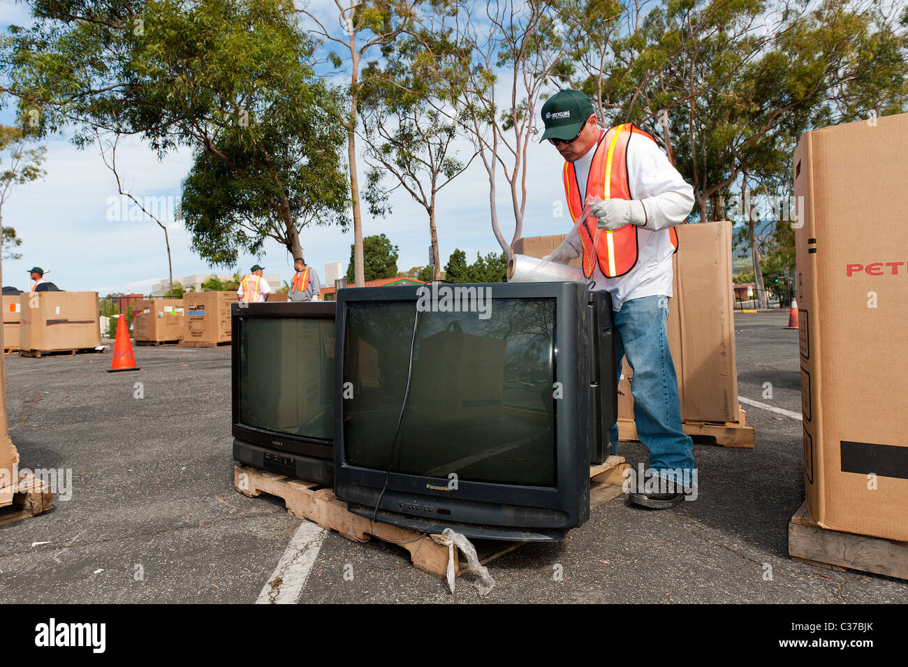 Recycling workers help in the collection, sorting, and packing of ...