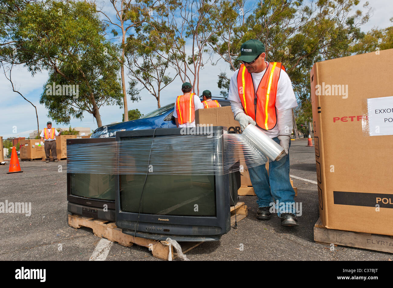 Recycling workers help in the collection, sorting, and packing of ...