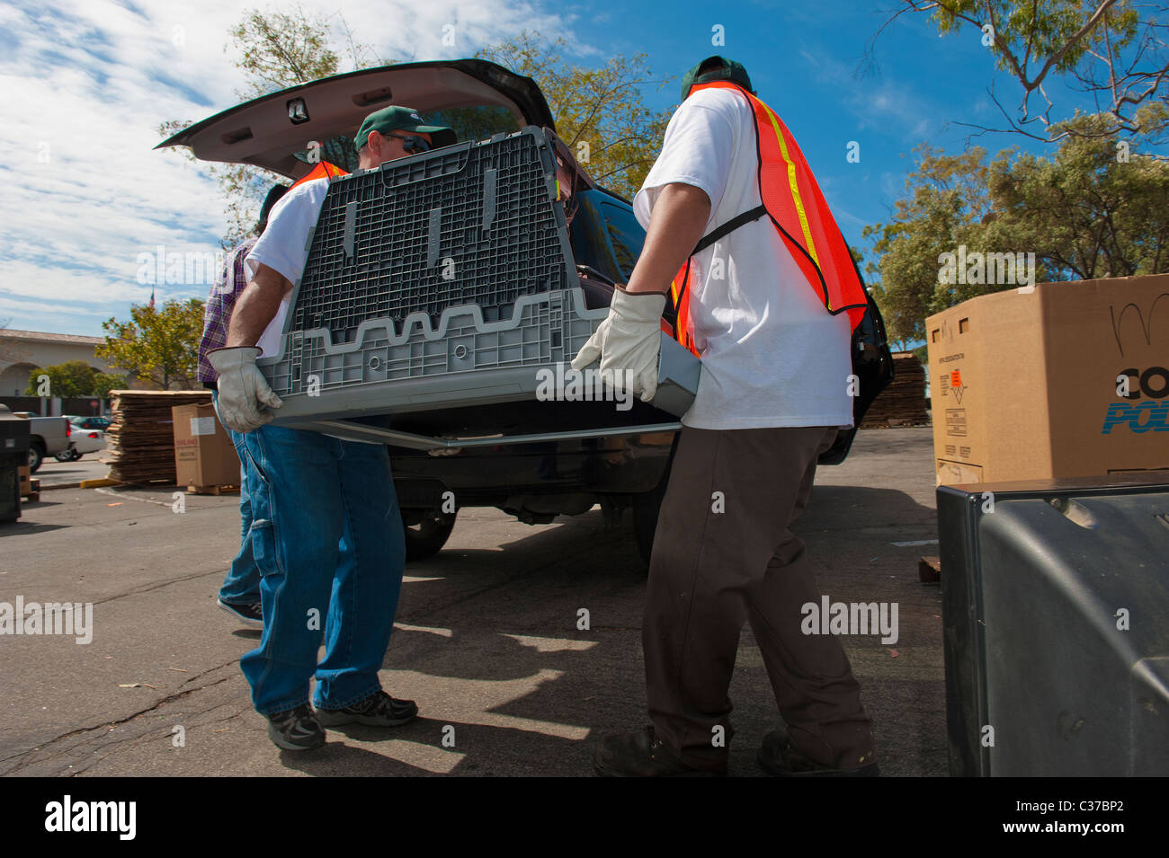 Recycling workers help in the collection, sorting, and packing of ...