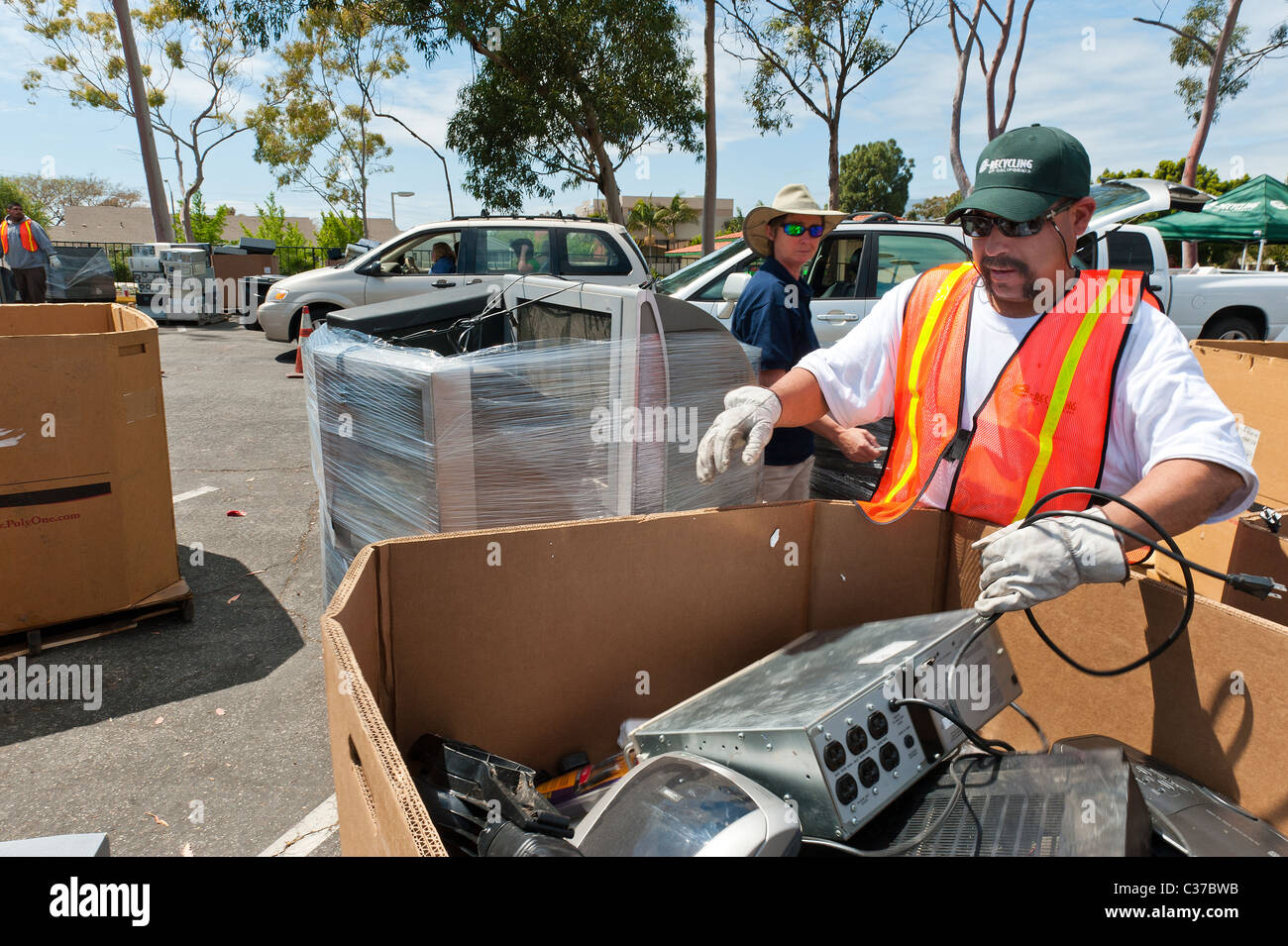 Recycling workers help in the collection, sorting, and packing of ...