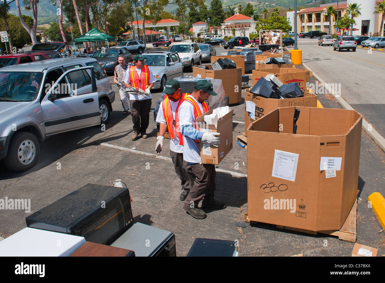 Recycling workers help in the collection, sorting, and packing of ...