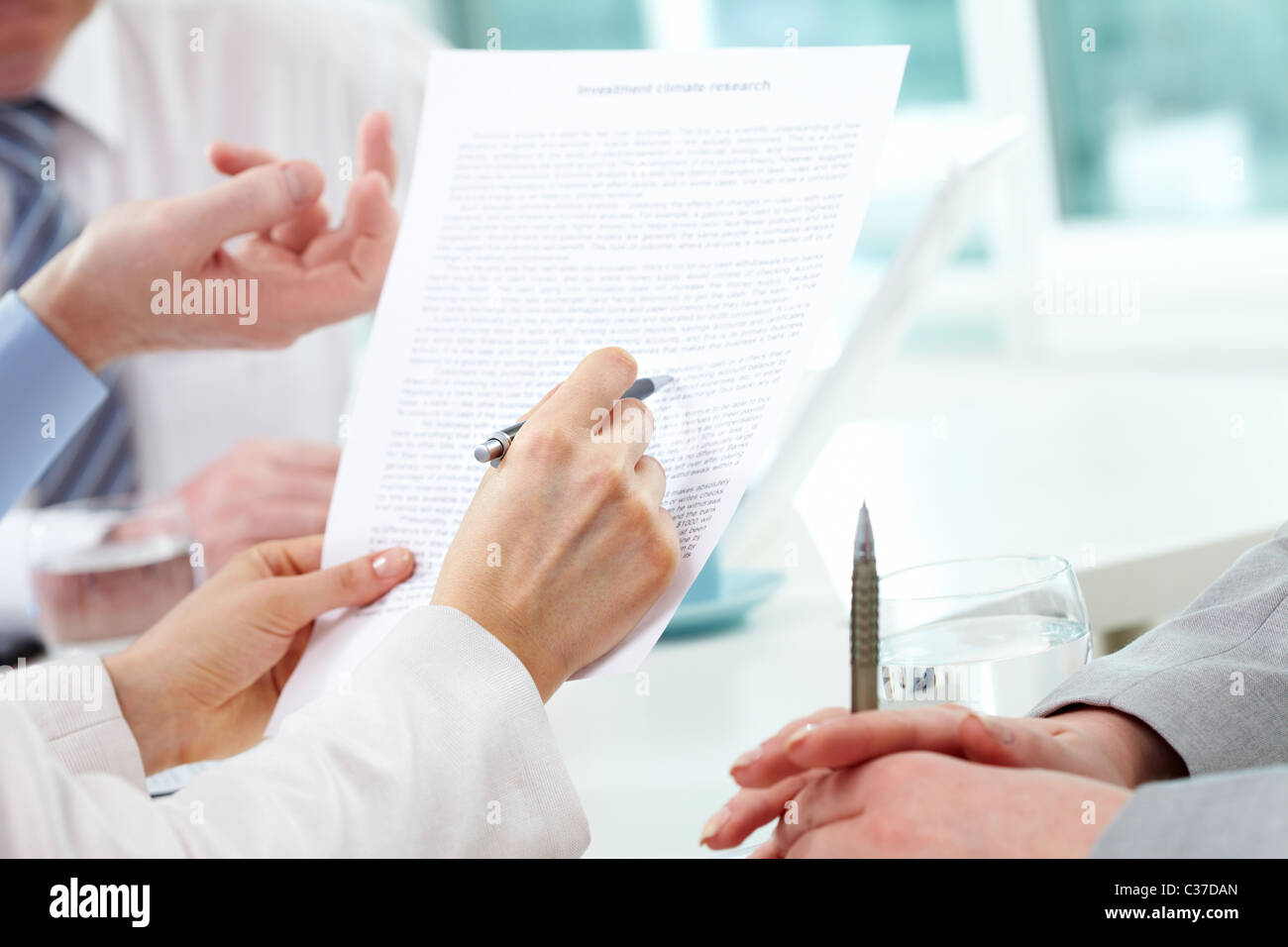 Image of human hand pointing at paper during explanation Stock Photo ...