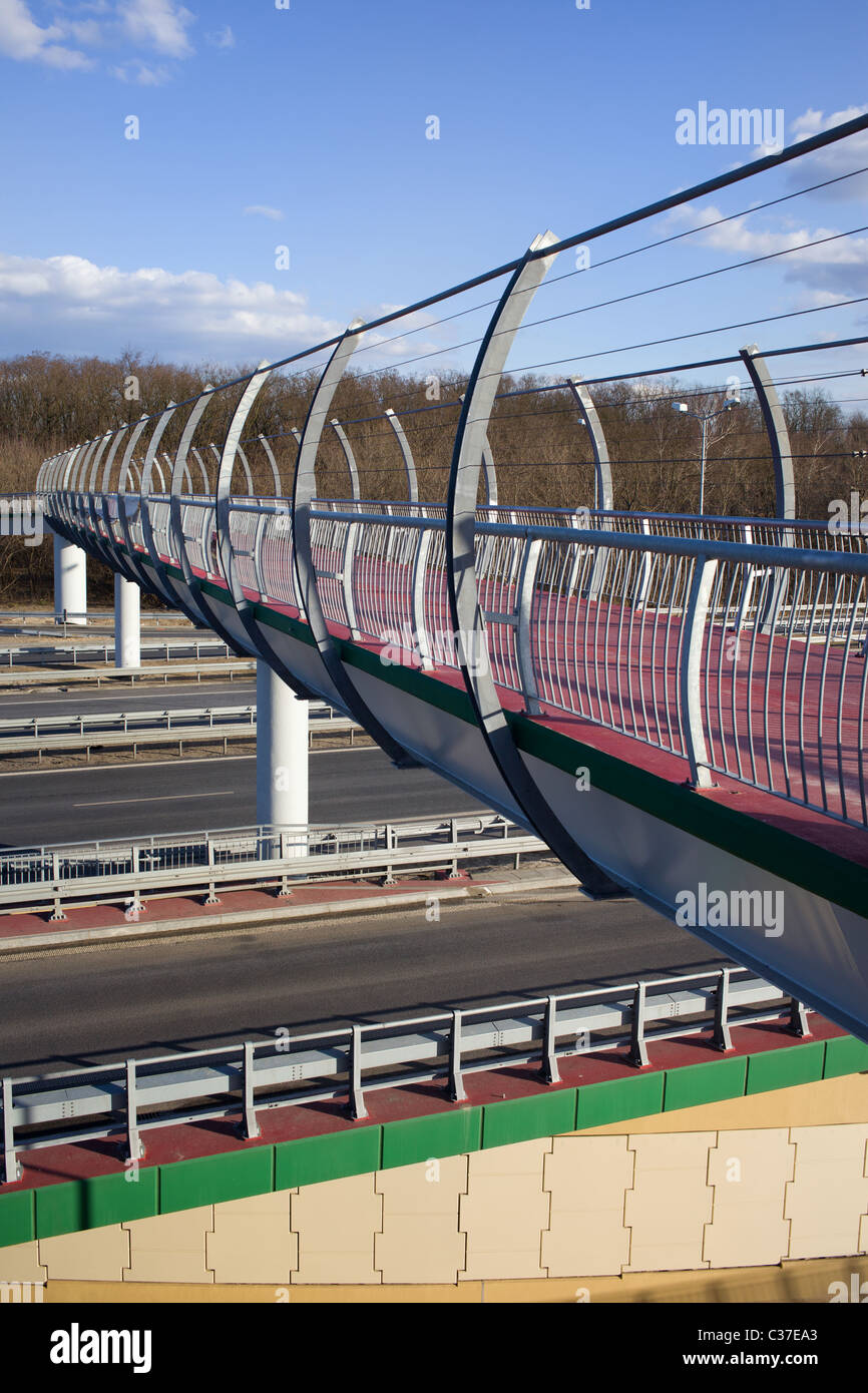 Urban scenery of a highway and pedestrian foot bridge in Warsaw, Poland ...