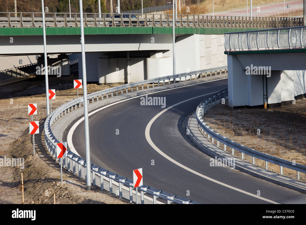 Street curve with red arrows roadsigns in Warsaw, Poland Stock Photo ...