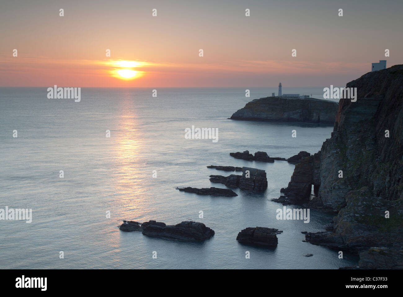Sunset over South Stack lighthouse, Anglesey, North Wales Stock Photo ...
