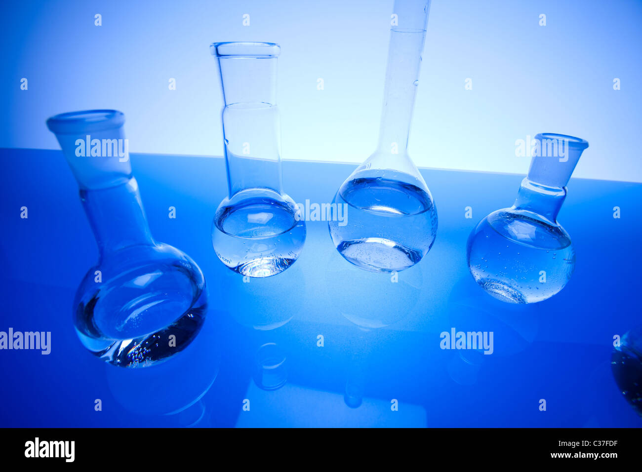 Laboratory glass in blue scenery Stock Photo - Alamy