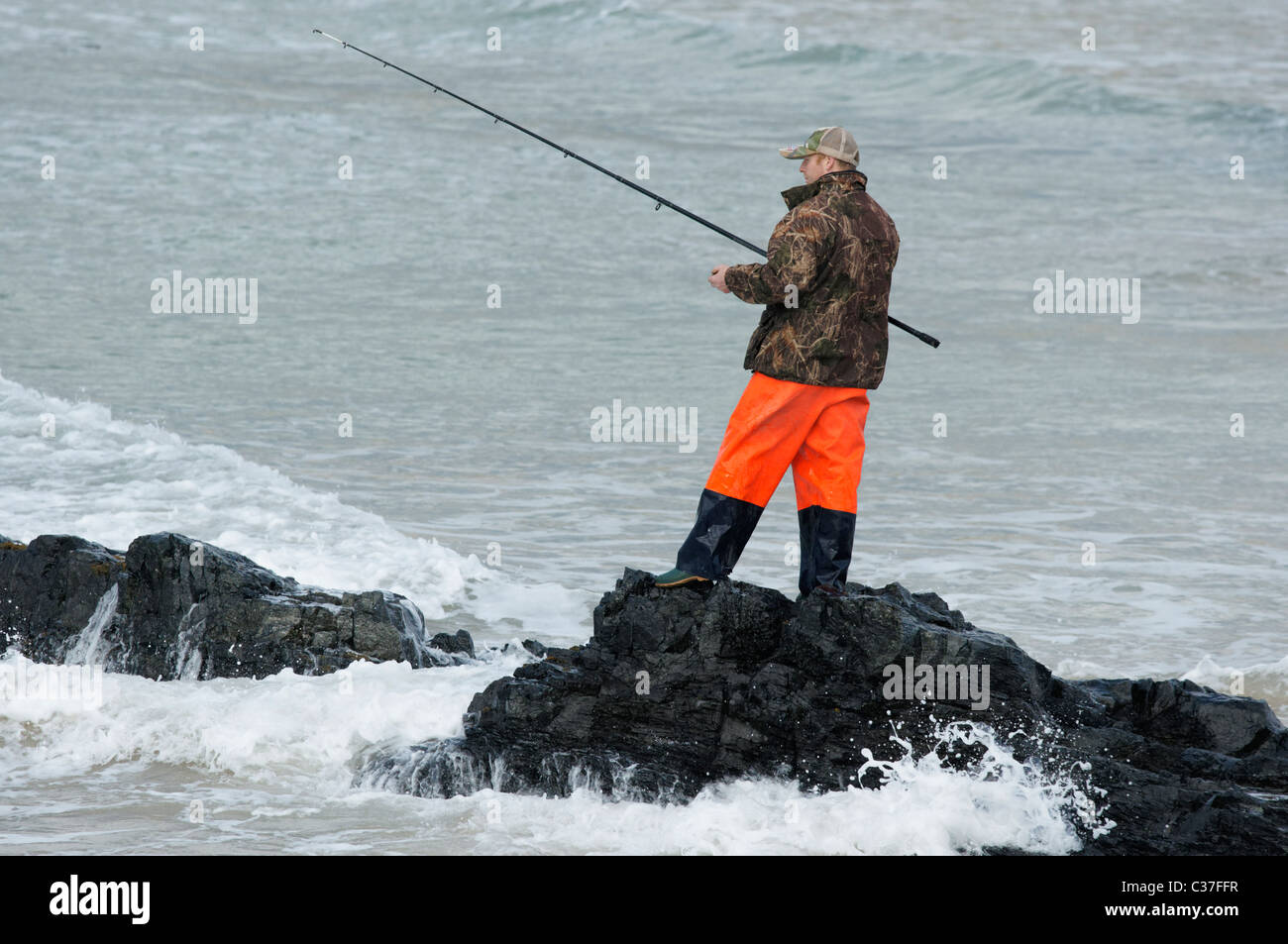 Man fishing off rocks hi-res stock photography and images - Alamy