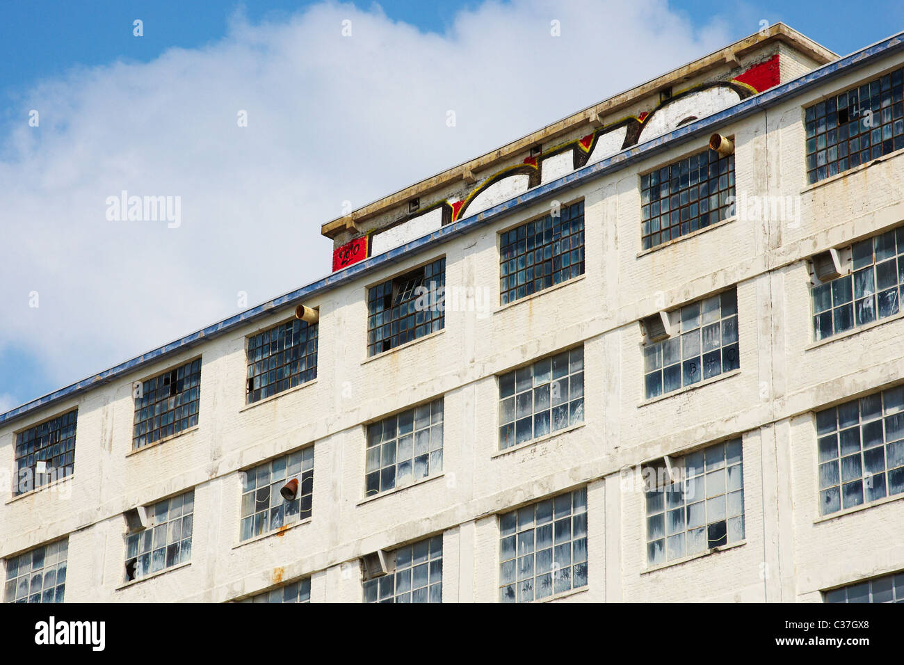 Old factory with graffiti painted on the top of the building Stock ...