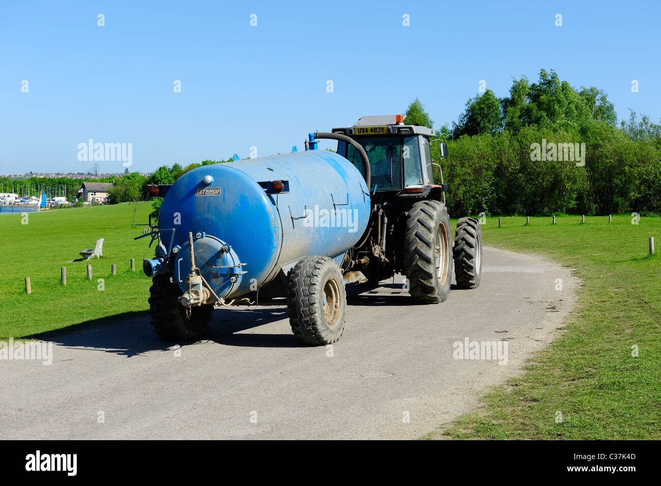 tractor pulling water tanker through rother valley country park england ...