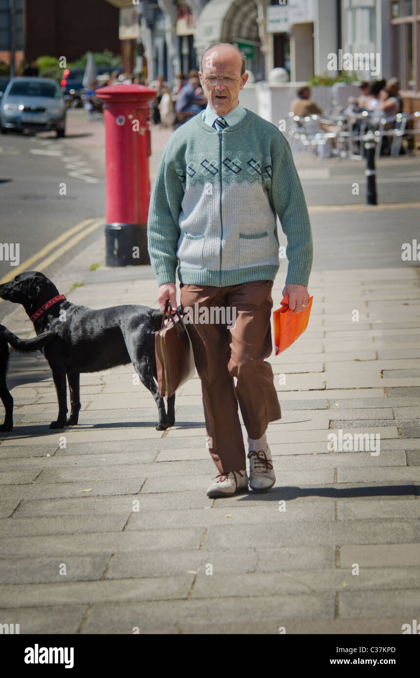 Elderly man walking down street in strange attire Stock Photo - Alamy