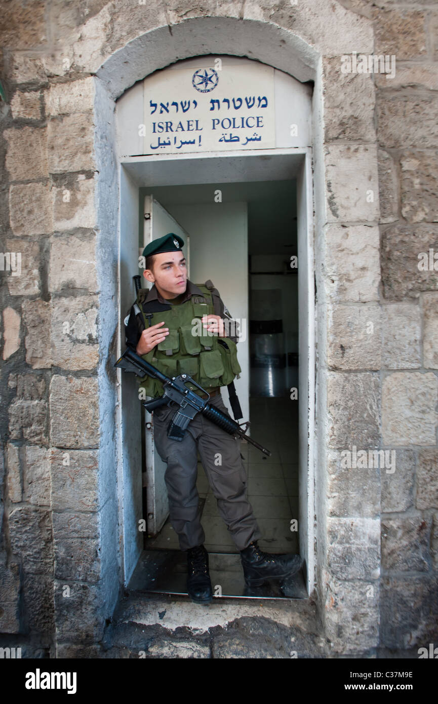 An Israeli border policeman stands in the doorway of his station in the ...