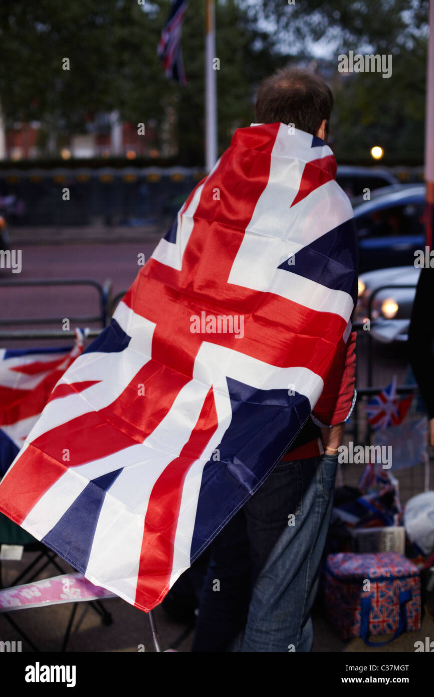 Union jack draped over a man with his back to the camera Stock Photo ...