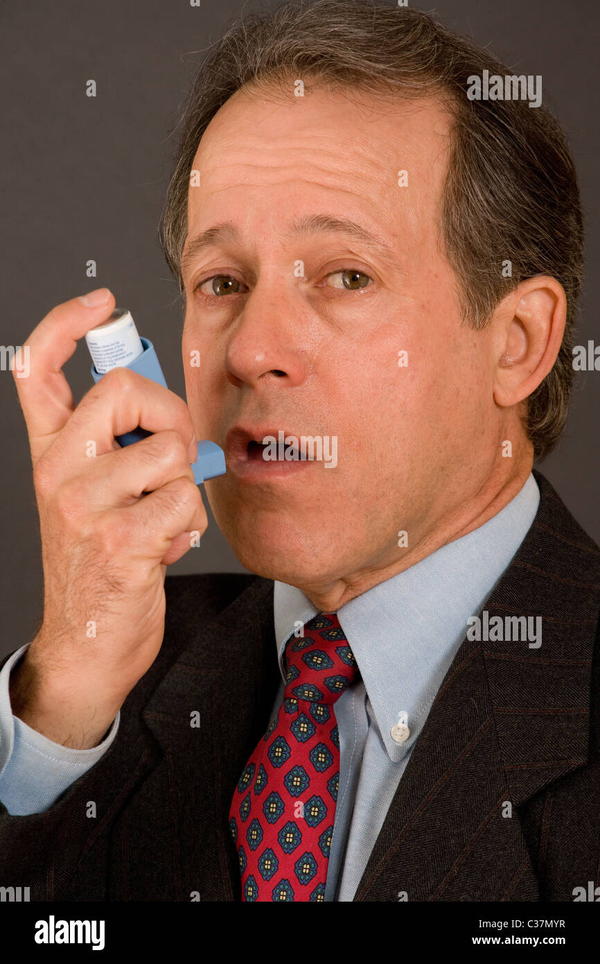 Portrait of Man using an Inhaler Stock Photo - Alamy