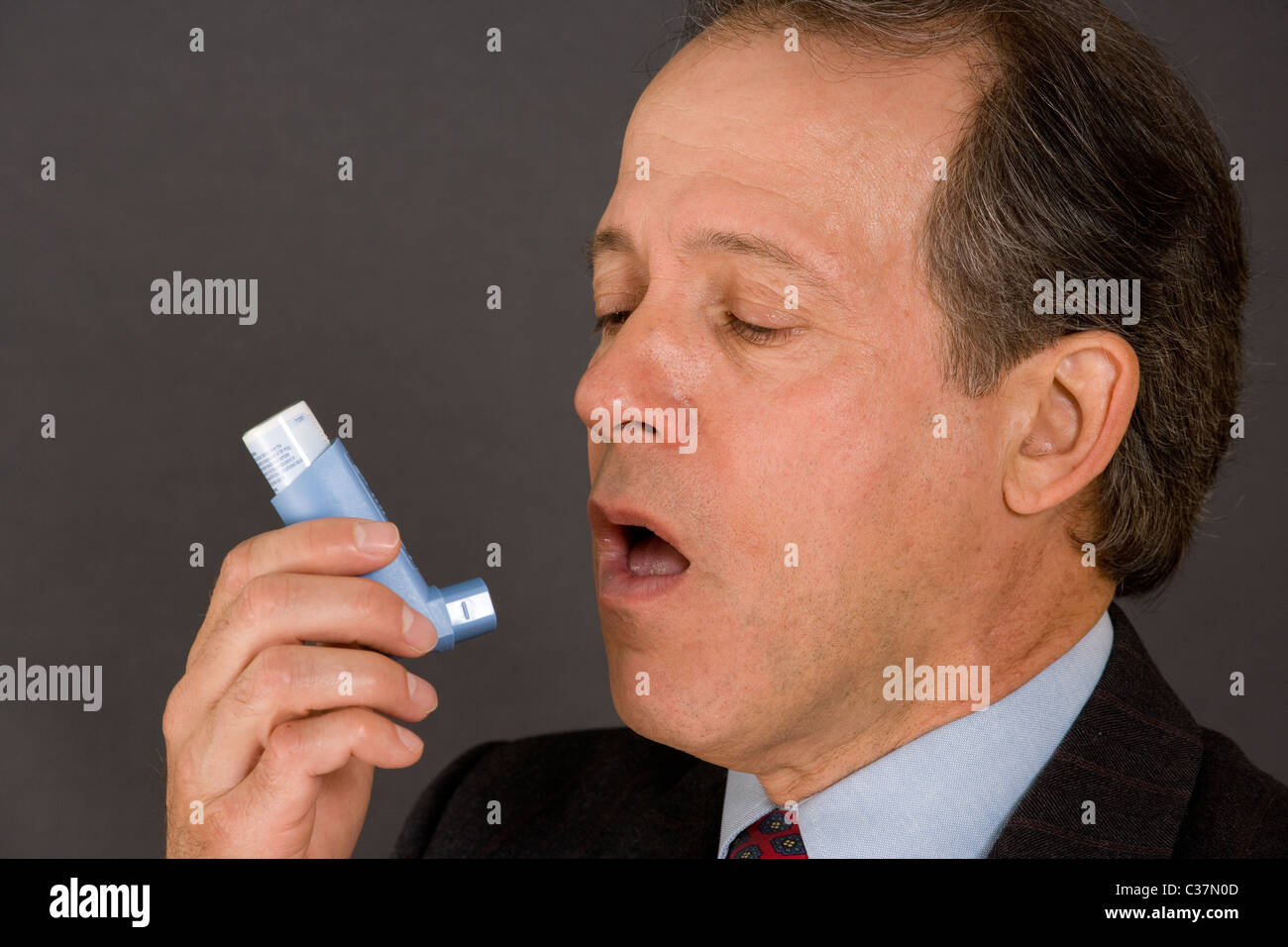 Portrait of Man using an Inhaler Stock Photo - Alamy