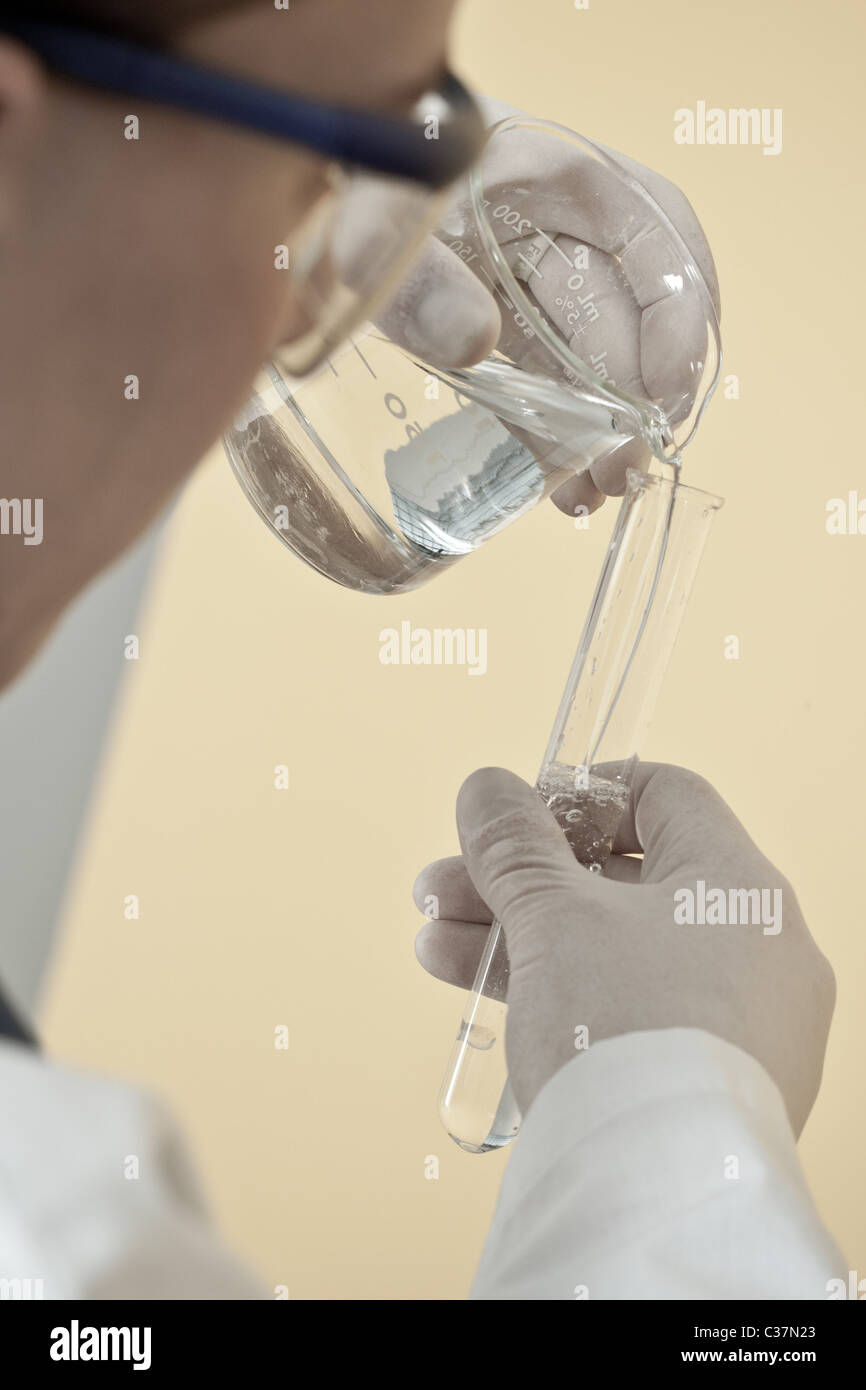 Water Quality Testing. Tech pouring water into test tube Stock Photo ...