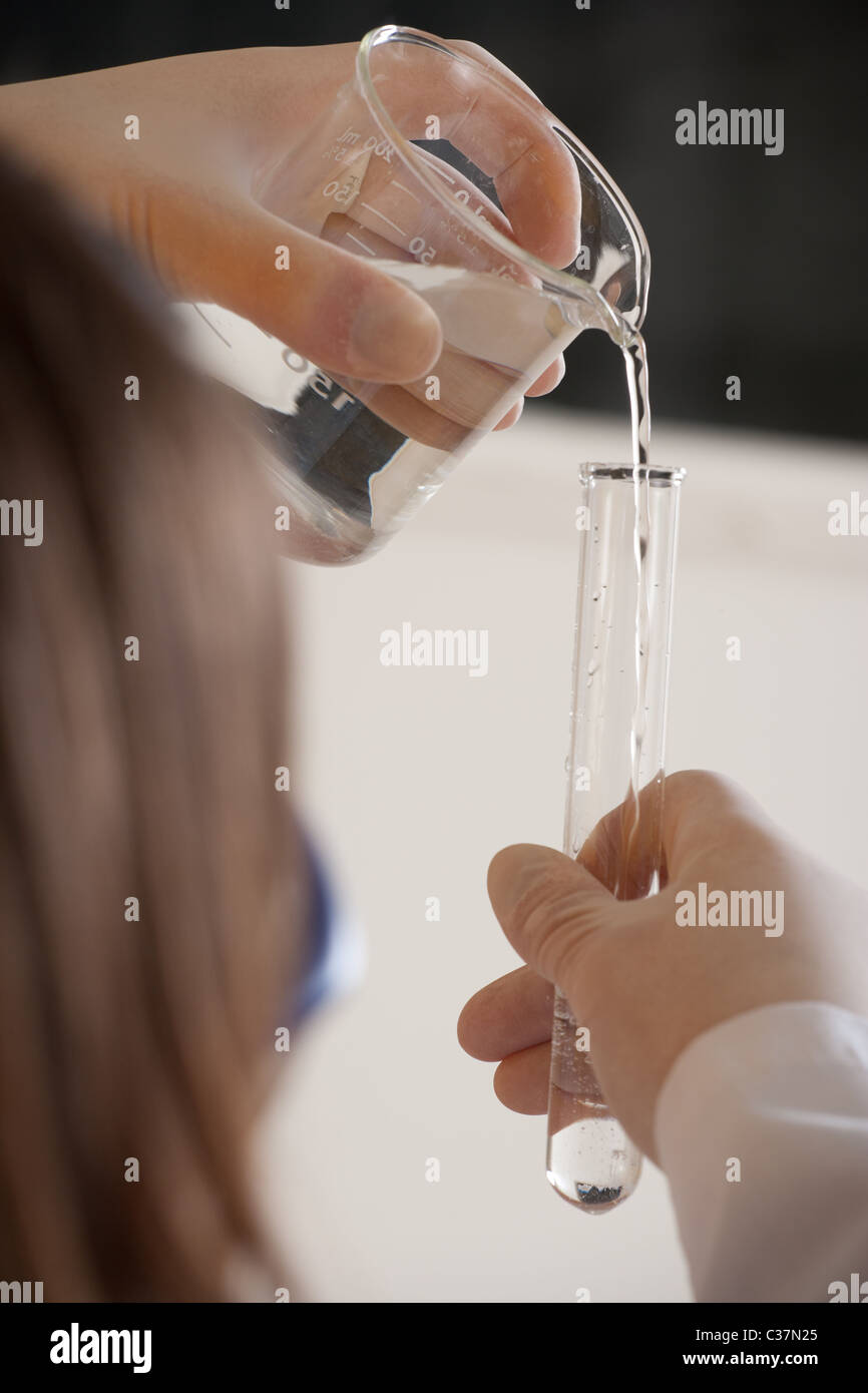 Water Quality Testing. Tech pouring water into test tube Stock Photo ...