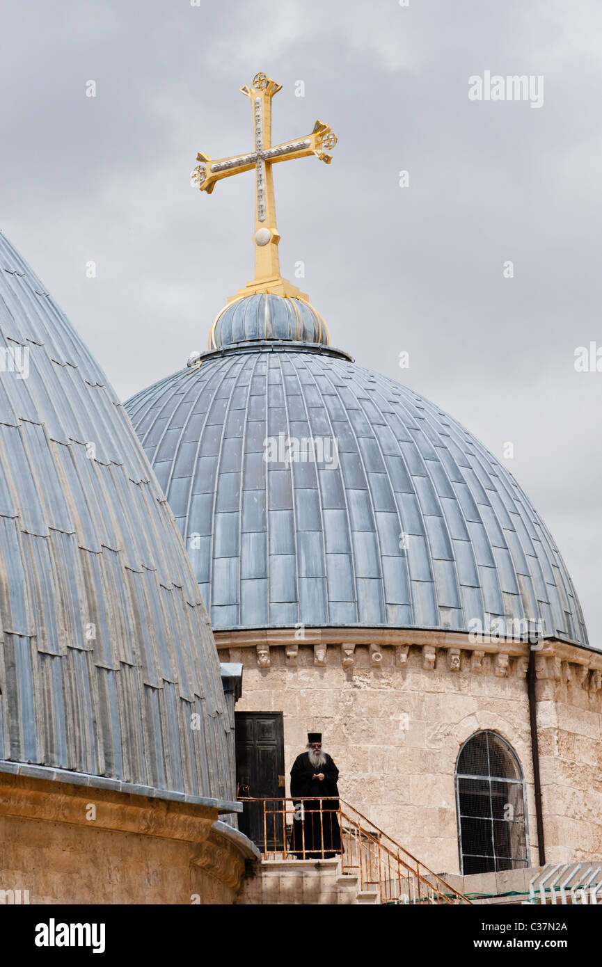 An orthodox Christian priest at the dome of the Church of the Holy ...