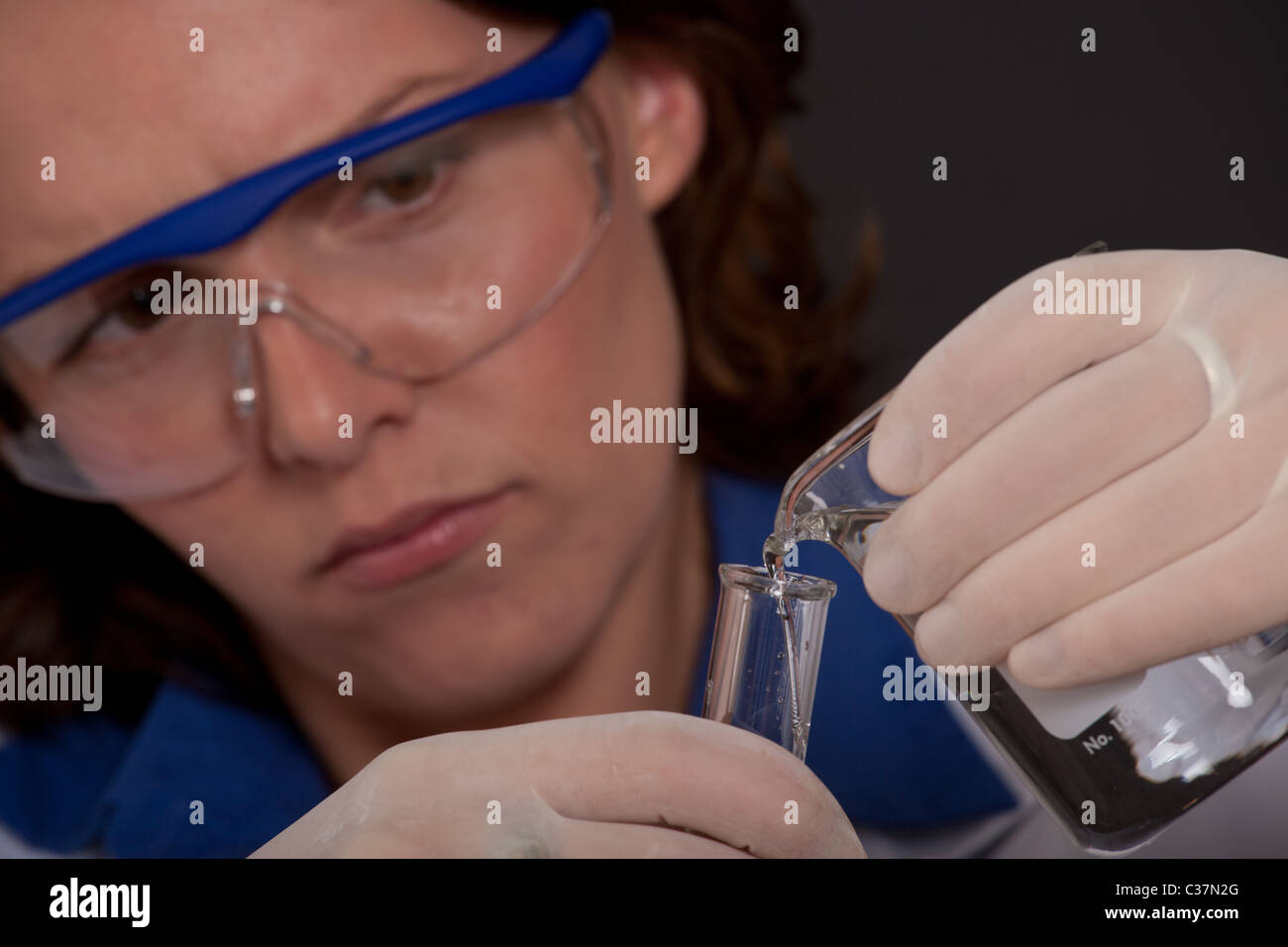 Water Quality Testing. Tech pouring water into test tube Stock Photo ...