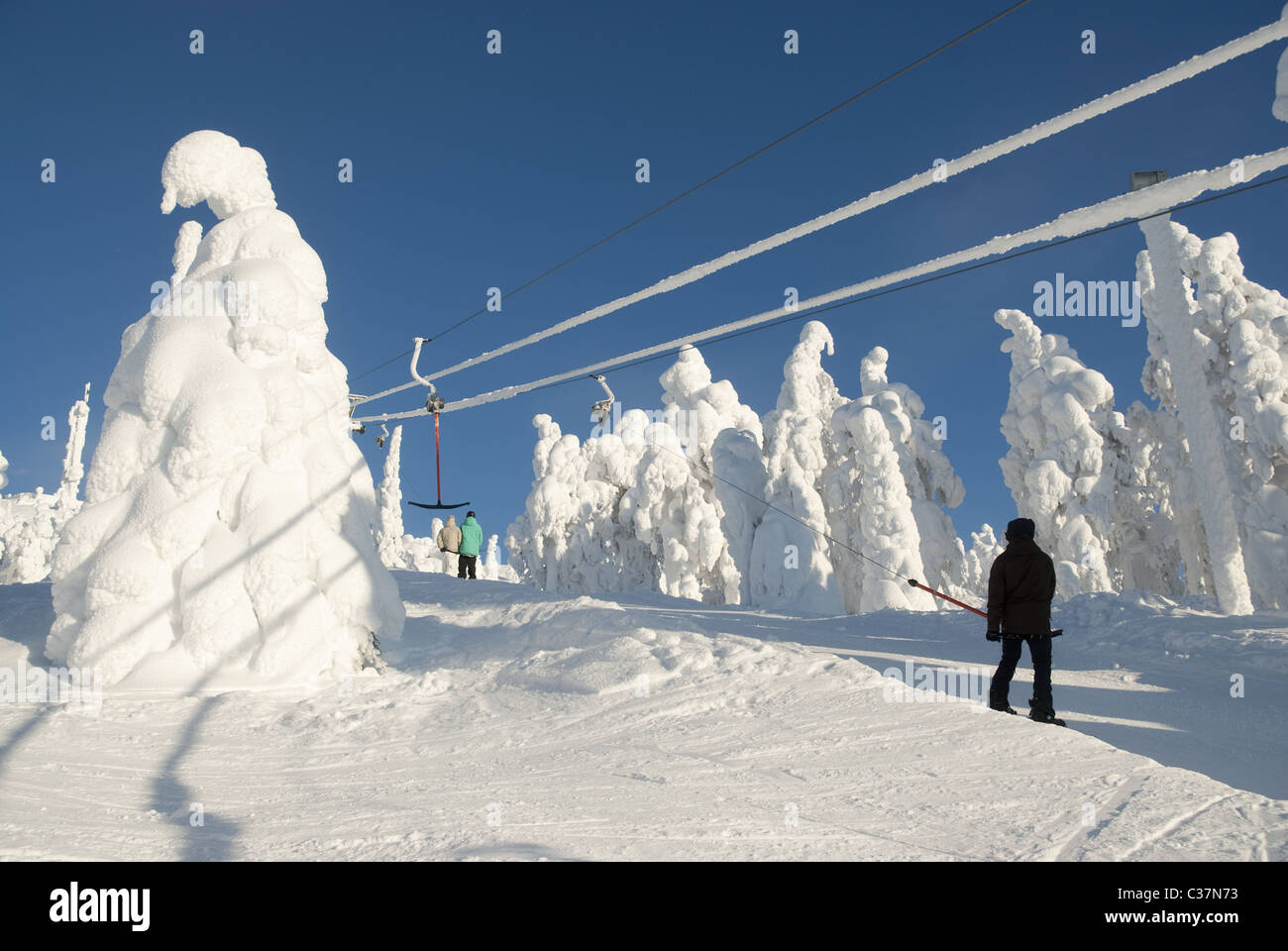 Skiers in a t-bar ski-lift in Ruka, Finland Stock Photo - Alamy