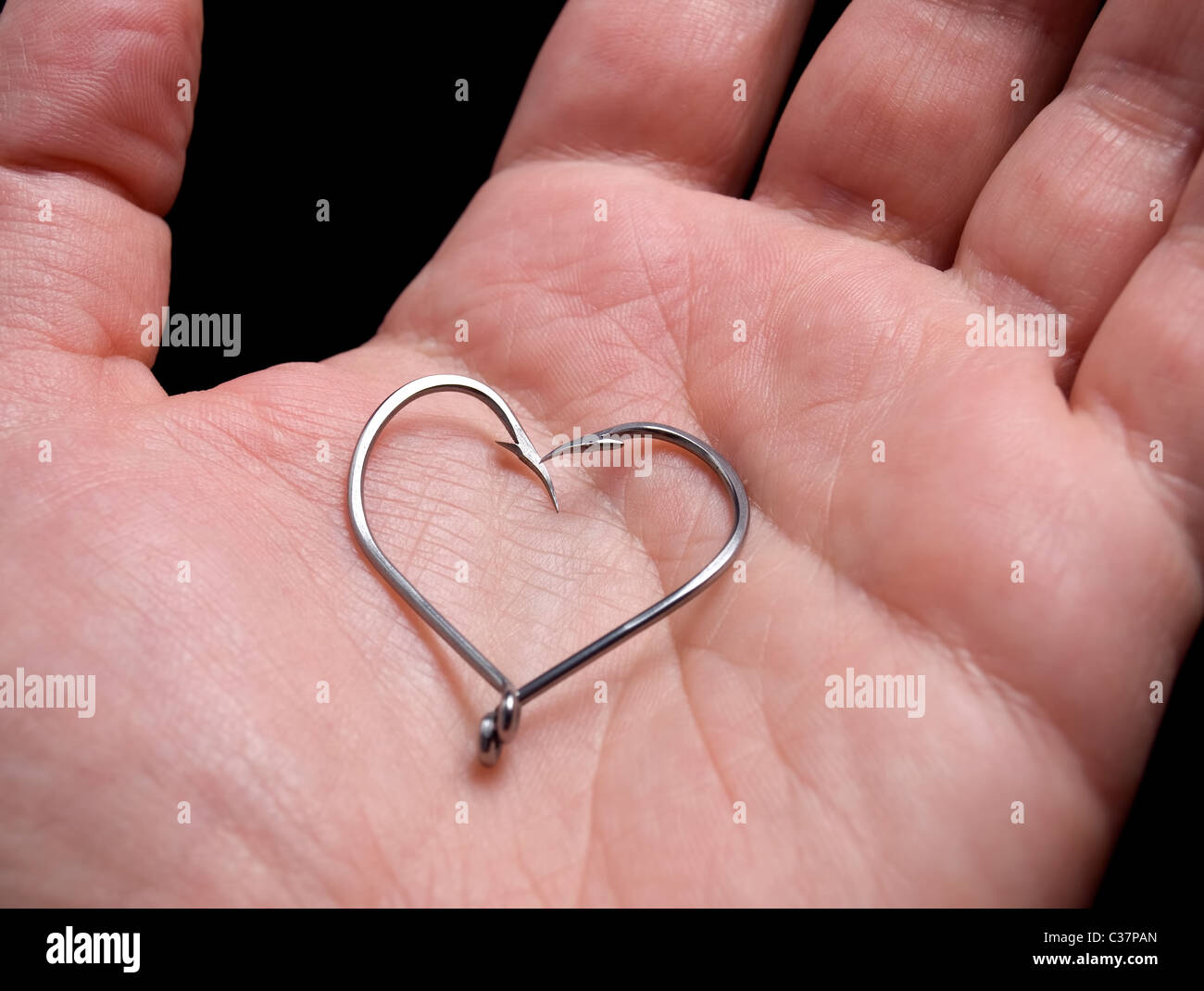 Shape or symbol of a heart in hand of an old fisherman Stock Photo - Alamy