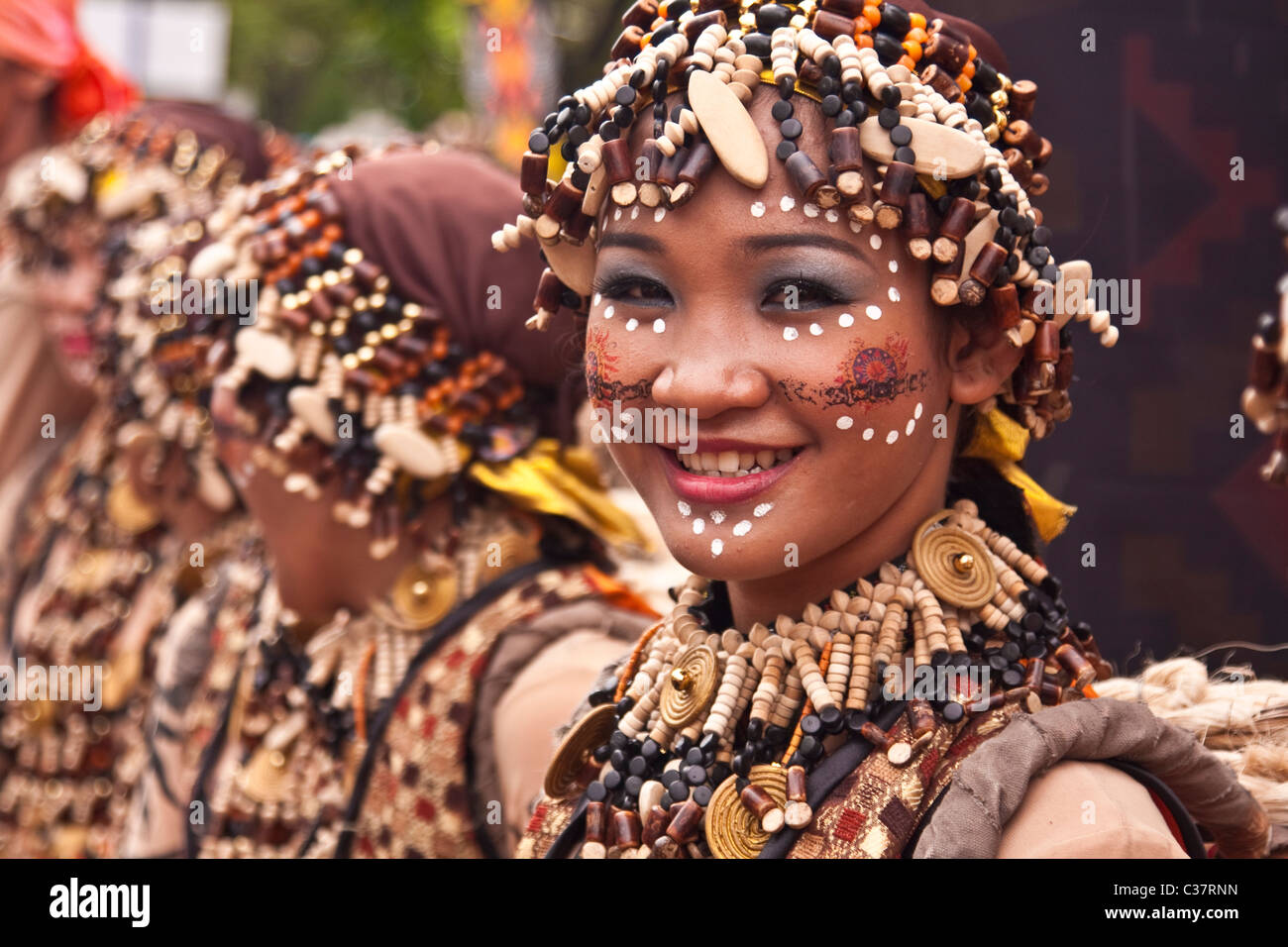 smiling woman in indigenous attire prepare for a street dancing ...