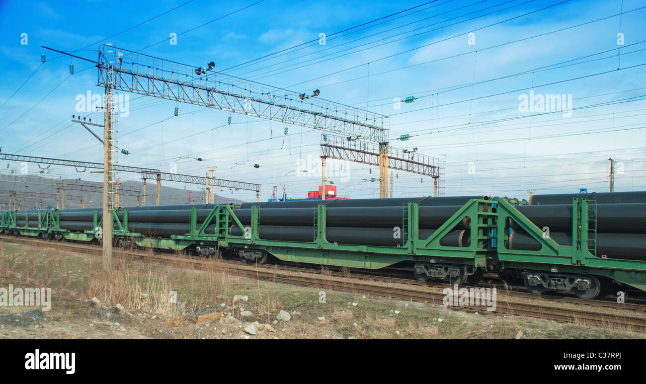 Railroad flatcars with pipes on railroad station Stock Photo - Alamy