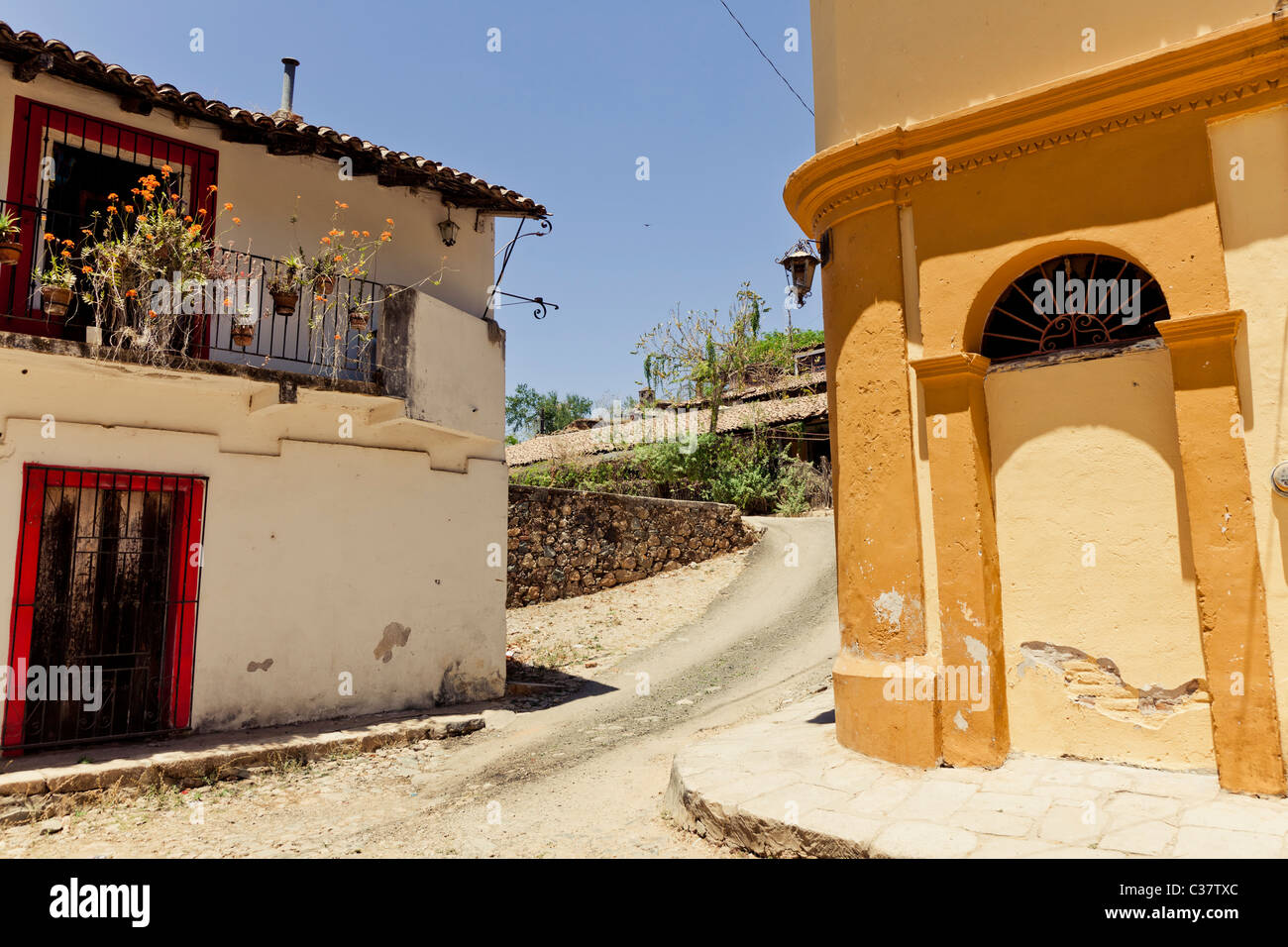 Brightly painted colonial buildings in a sunlit street of Copala ...