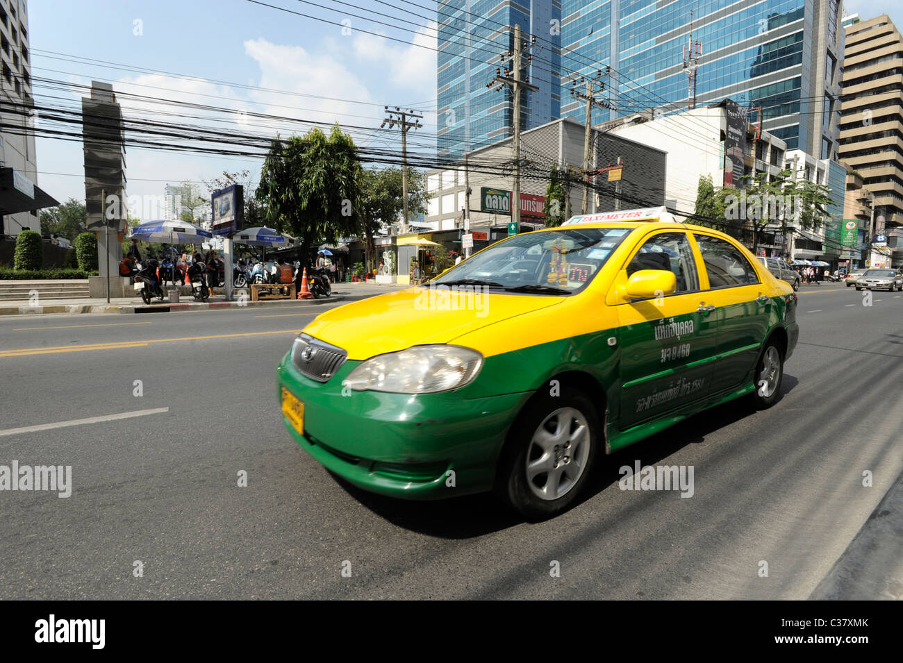 green and yellow taxi, main street in downtown bangkok, thailand Stock ...